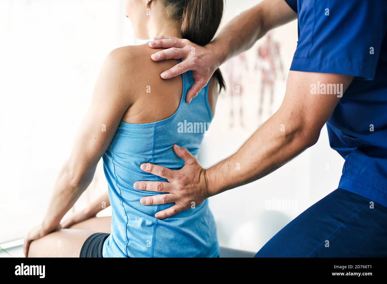 Male Physical Therapist Stretching a Female Patient Slowly Stock Photo ...