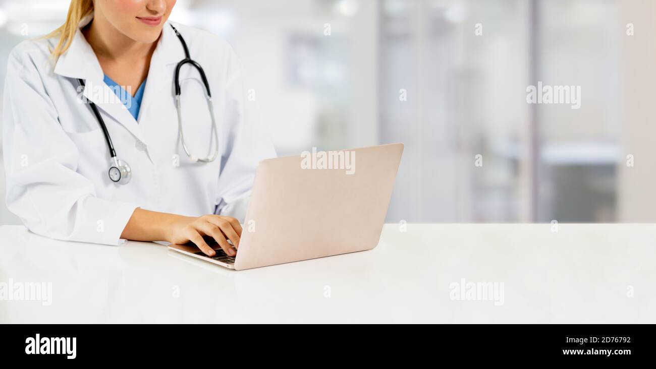 Doctor using laptop computer at the hospital. Medical healthcare and ...