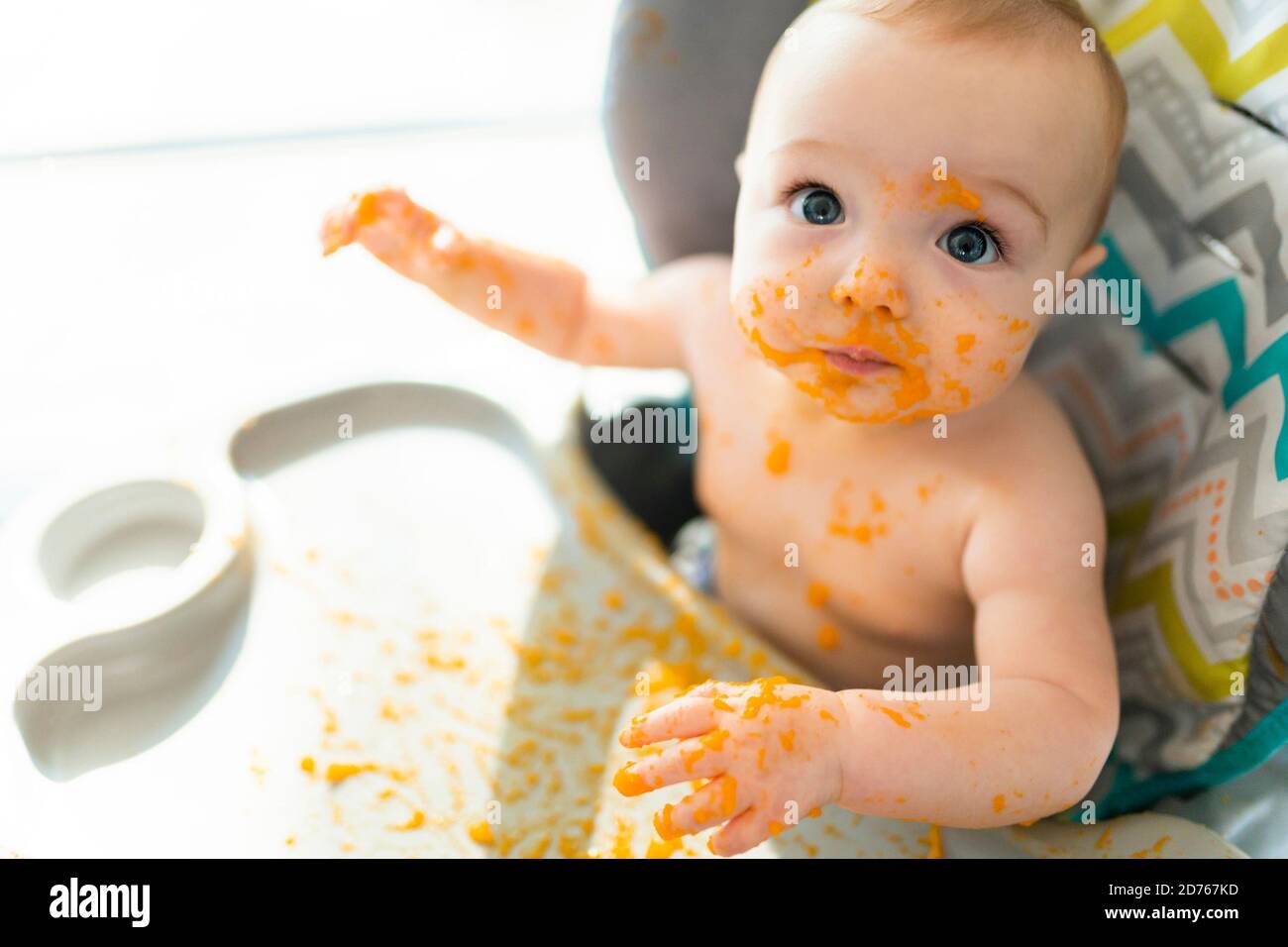A happy little cute daughter with mash food everywhere Stock Photo - Alamy