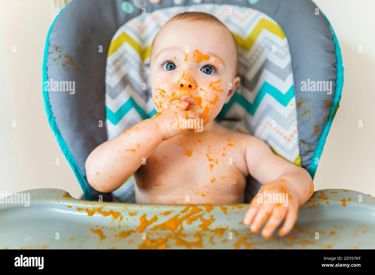 A happy little cute daughter with mash food everywhere Stock Photo - Alamy