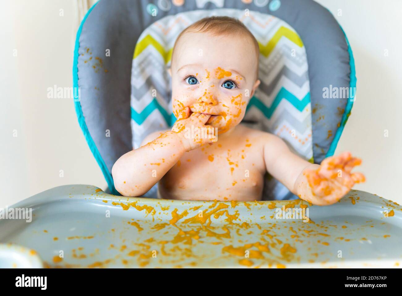 A happy little cute daughter with mash food everywhere Stock Photo - Alamy