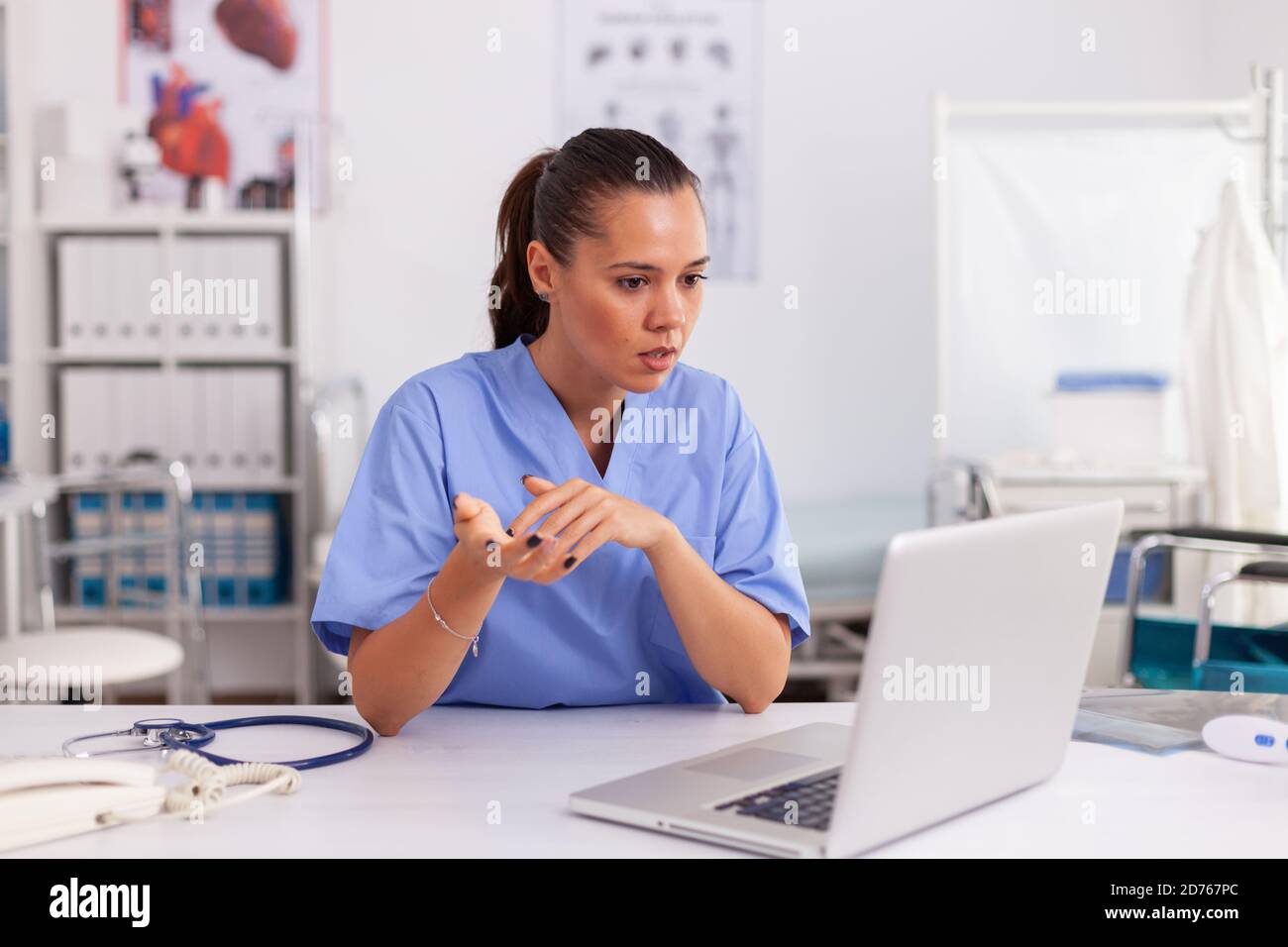 Confused medical practitioner in hospital office while working on ...