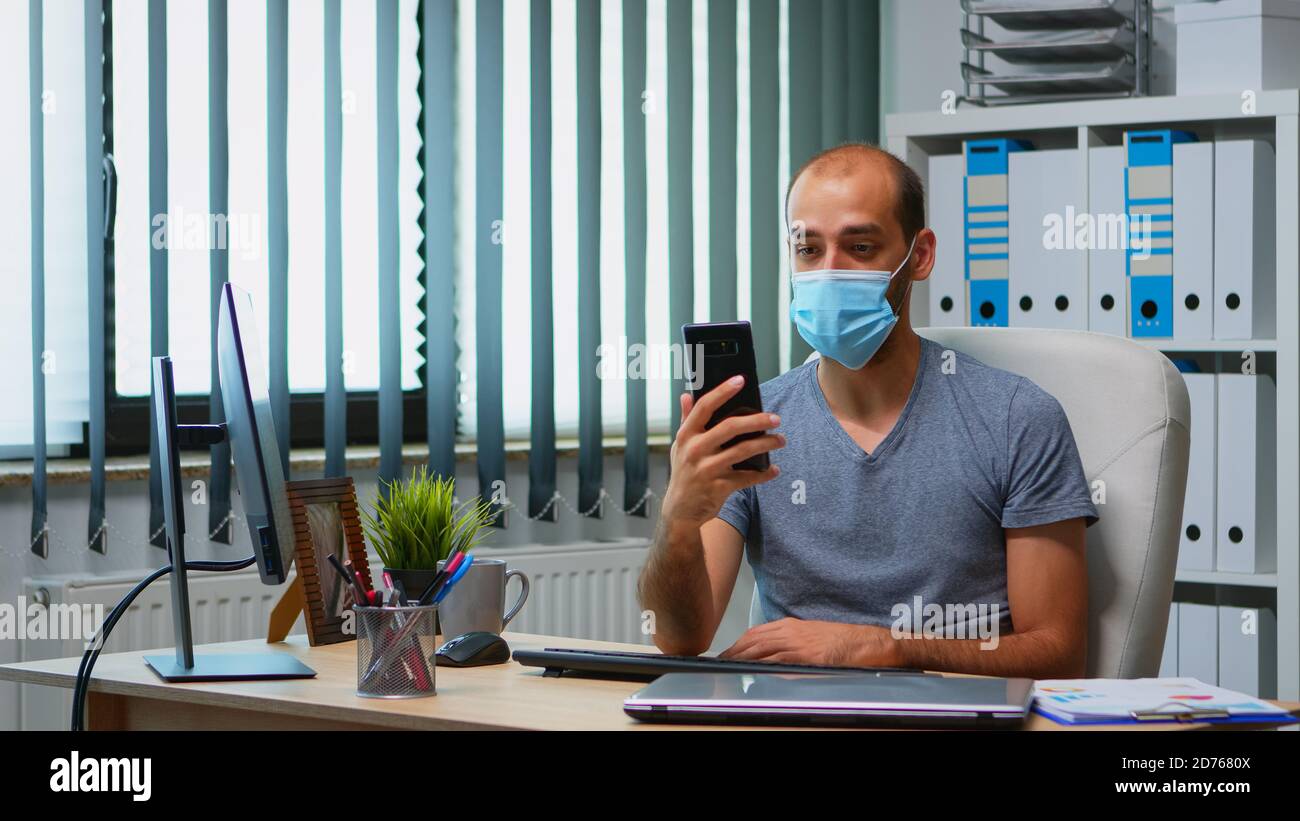 Man wearing protection face mask using smartphone webcam having virtual ...