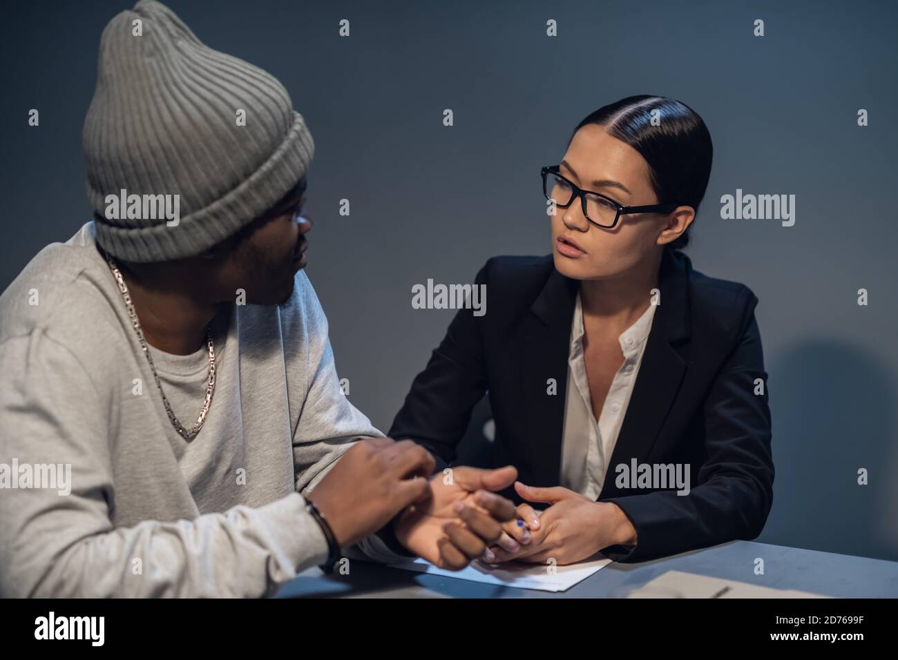 In the interrogation room, a suspect in a drug distribution and ...