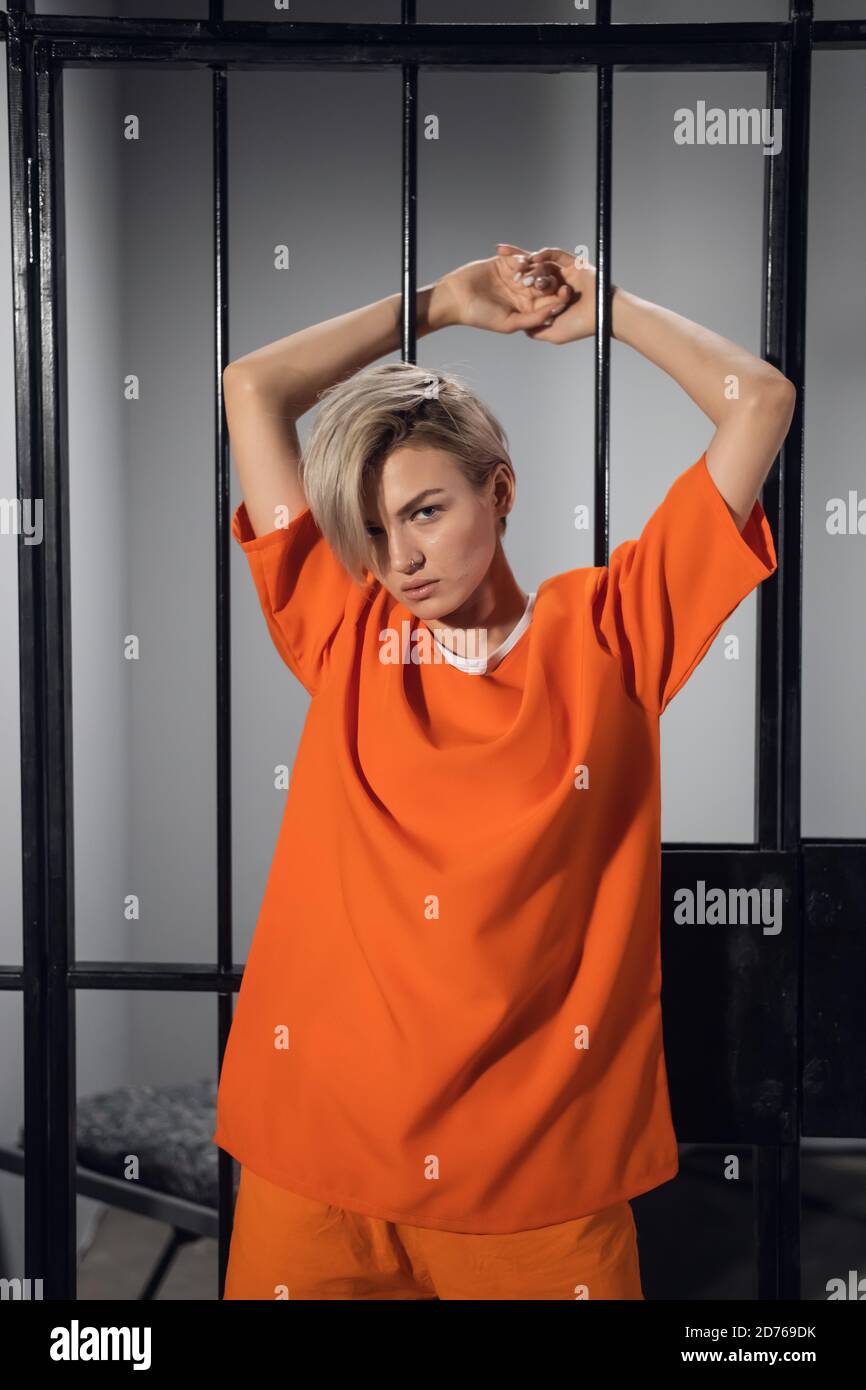 Cute blonde on a photo shoot in the prison, stays behind bars Stock ...
