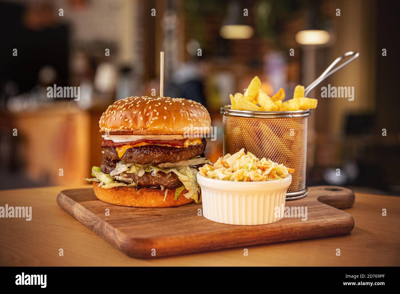 Double beef burger with cheddar and bacon served with fries and ...
