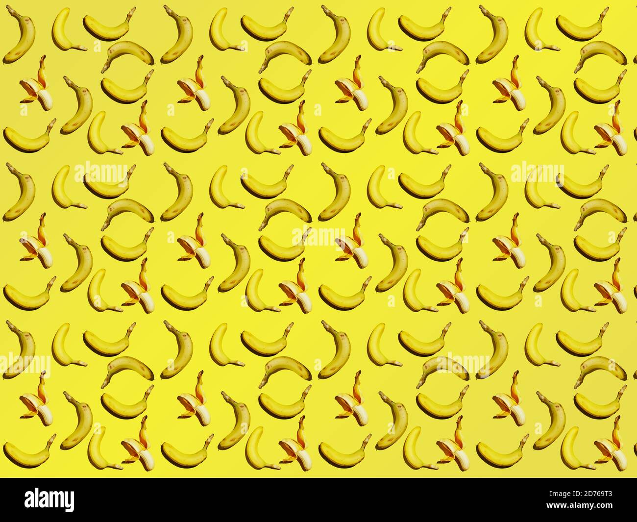 A pattern from a whole ripe and peeled bananas isolated on a yellow ...