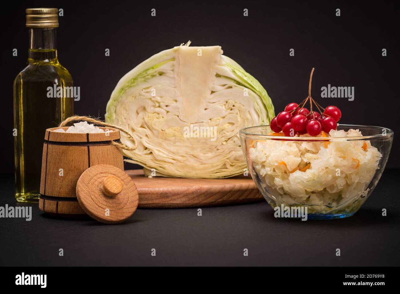 Homemade fermented cabbage in a glass bowl. Fresh head of a cabbage ...