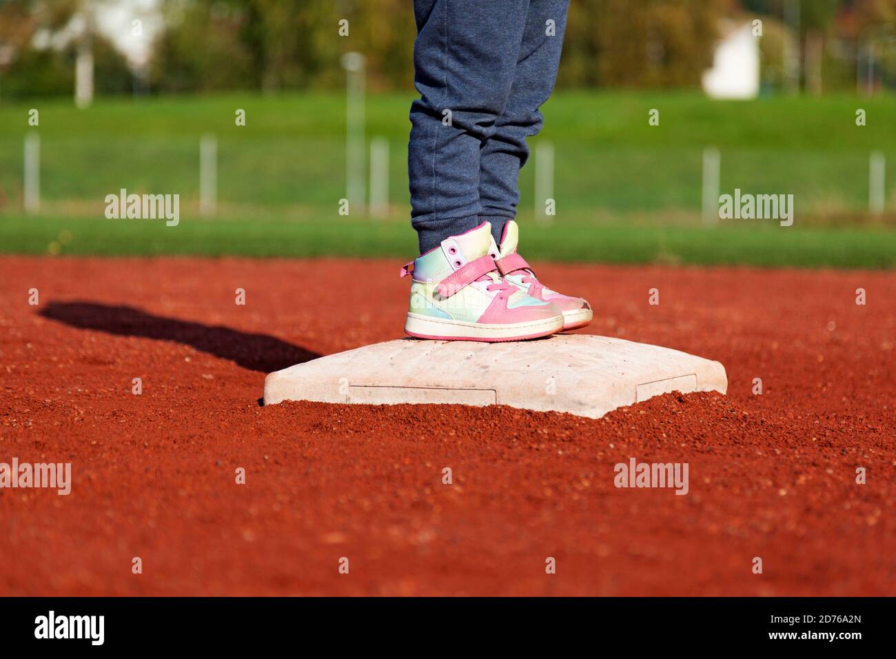 little guy standing on one of the baseball bases Stock Photo - Alamy