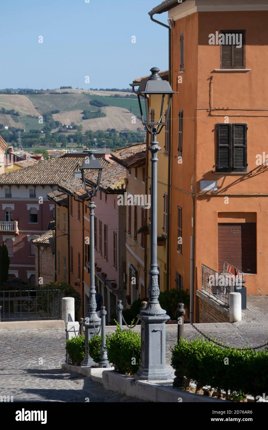 a typical steep street of Mondolfo city with the background of the ...