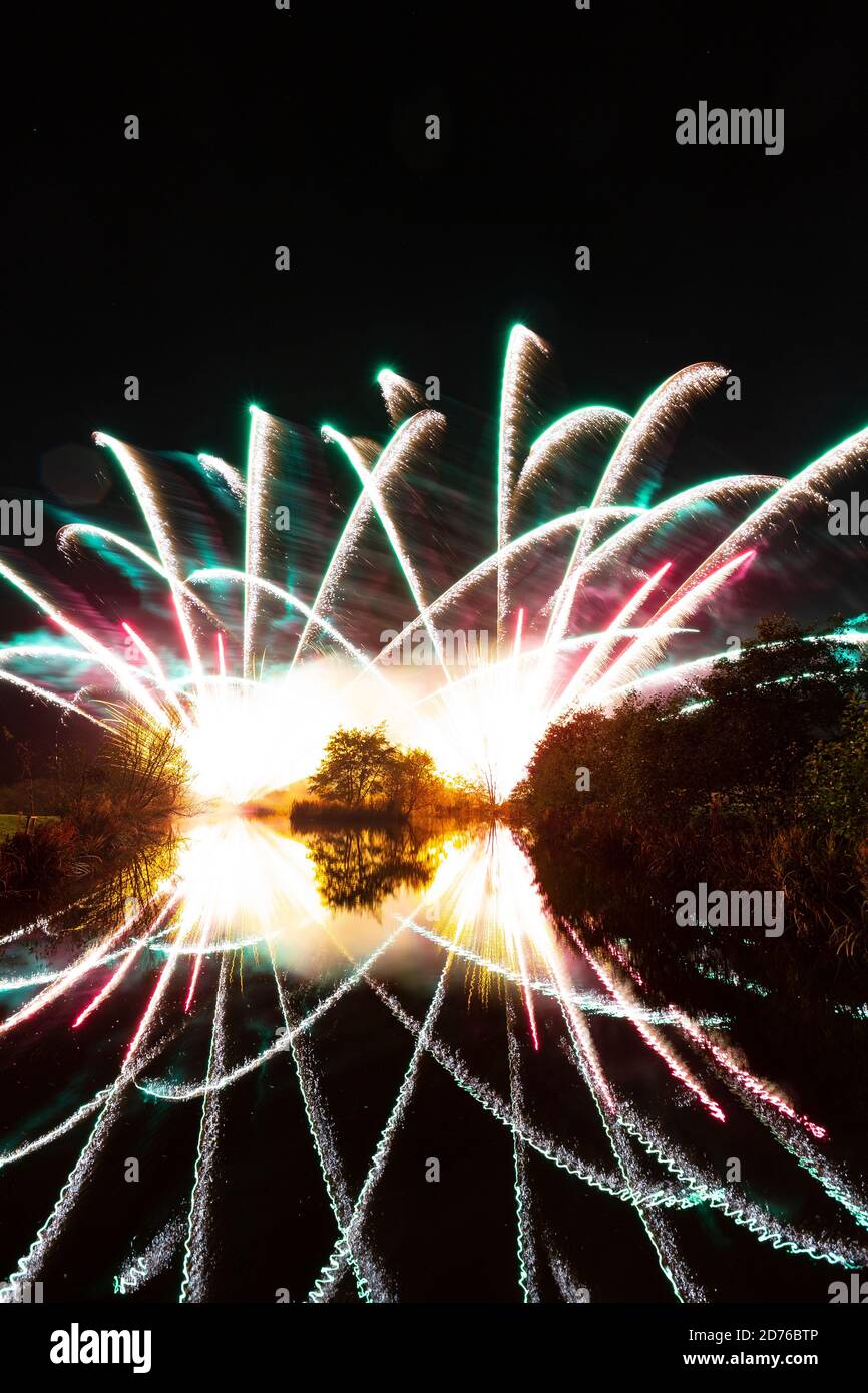 Spectacular and colourful firework display set against a dark Autumn ...