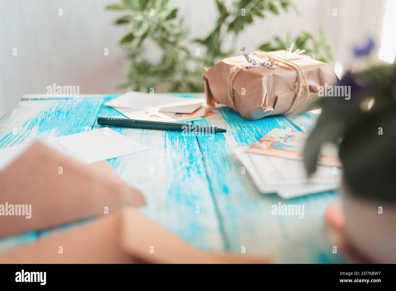 Vintage composition of postcards, pen and parcel. Side view. Blue ...