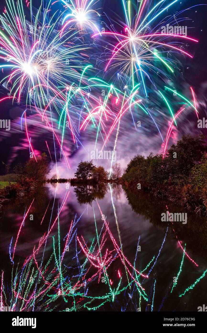 Spectacular and colourful firework display set against a dark Autumn ...