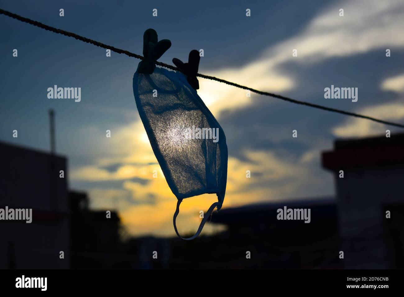 Medical face mask hung on the rope against the sky during sunset Stock ...