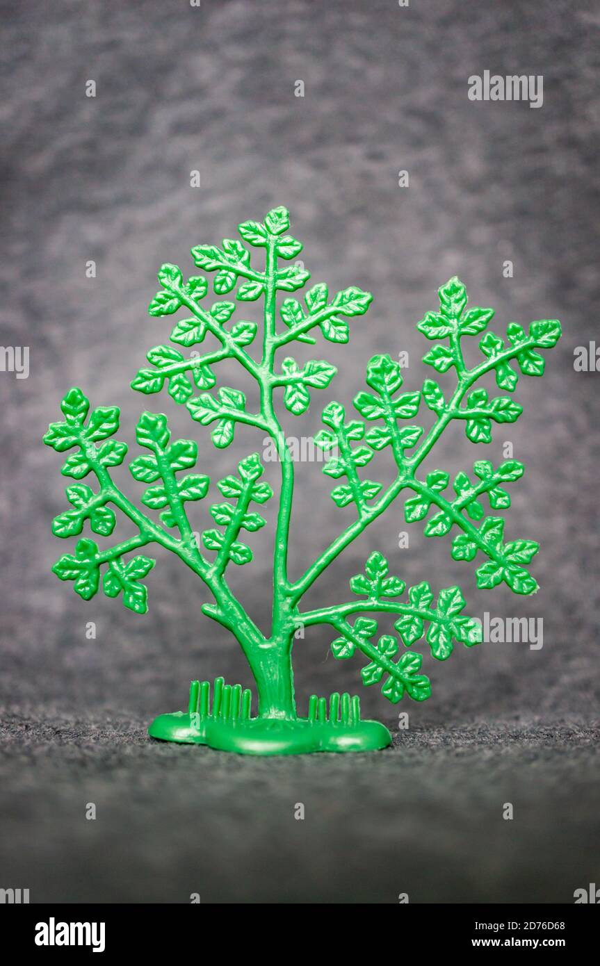 Vertical closeup of a toy tree figurine on gray background Stock Photo ...
