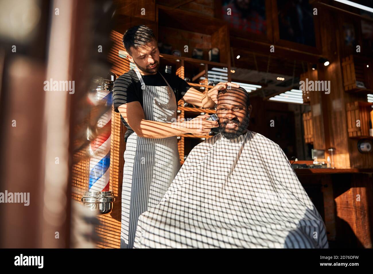 Male barber shaving client beard with electric razor Stock Photo - Alamy