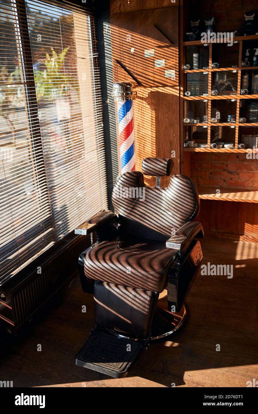 Interior of barbershop with professional barber chair Stock Photo - Alamy