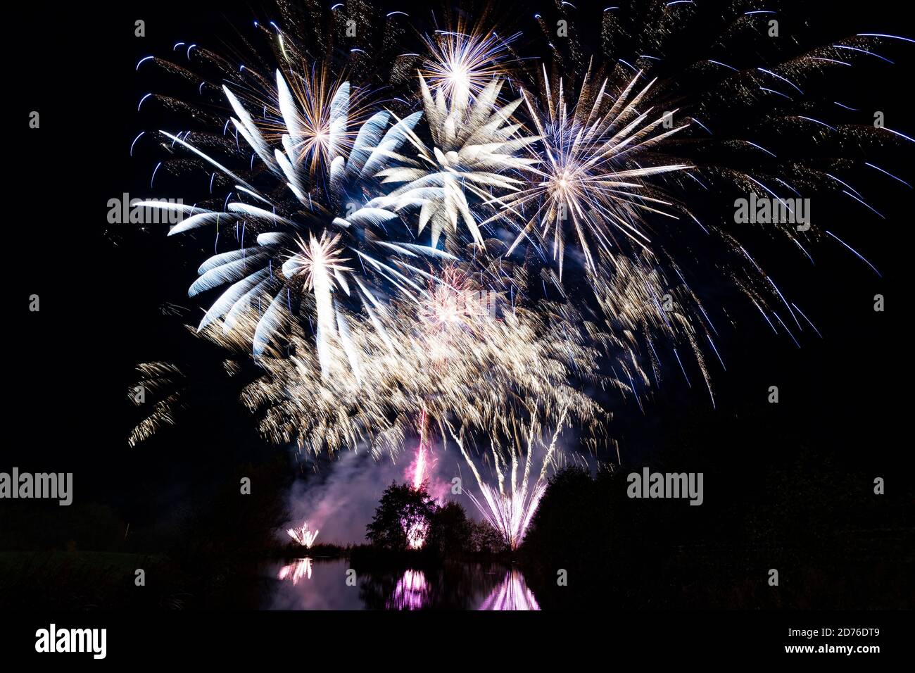 Spectacular and colourful firework display set against a dark Autumn ...