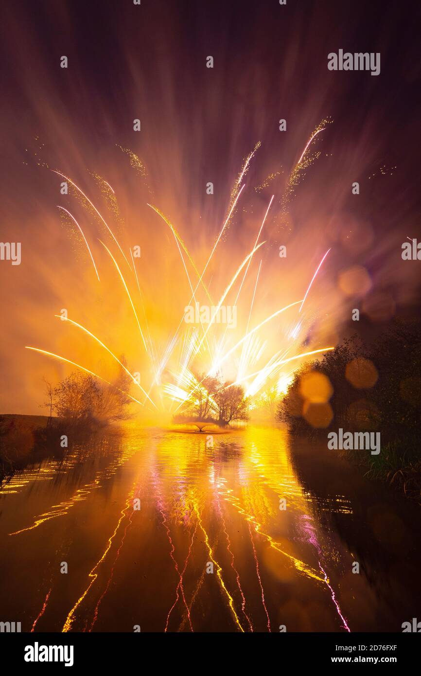 Spectacular and colourful firework display set against a dark Autumn ...