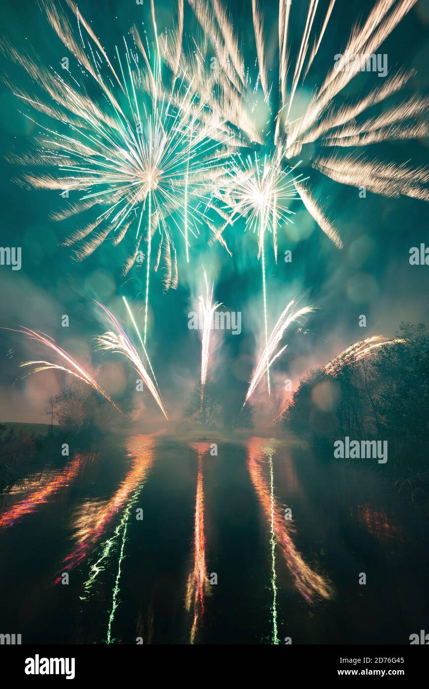 Spectacular and colourful firework display set against a dark Autumn ...