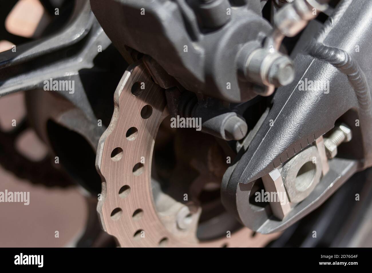 Rear axle of a sports motorcycle. Disc brake and axle in gray tones ...