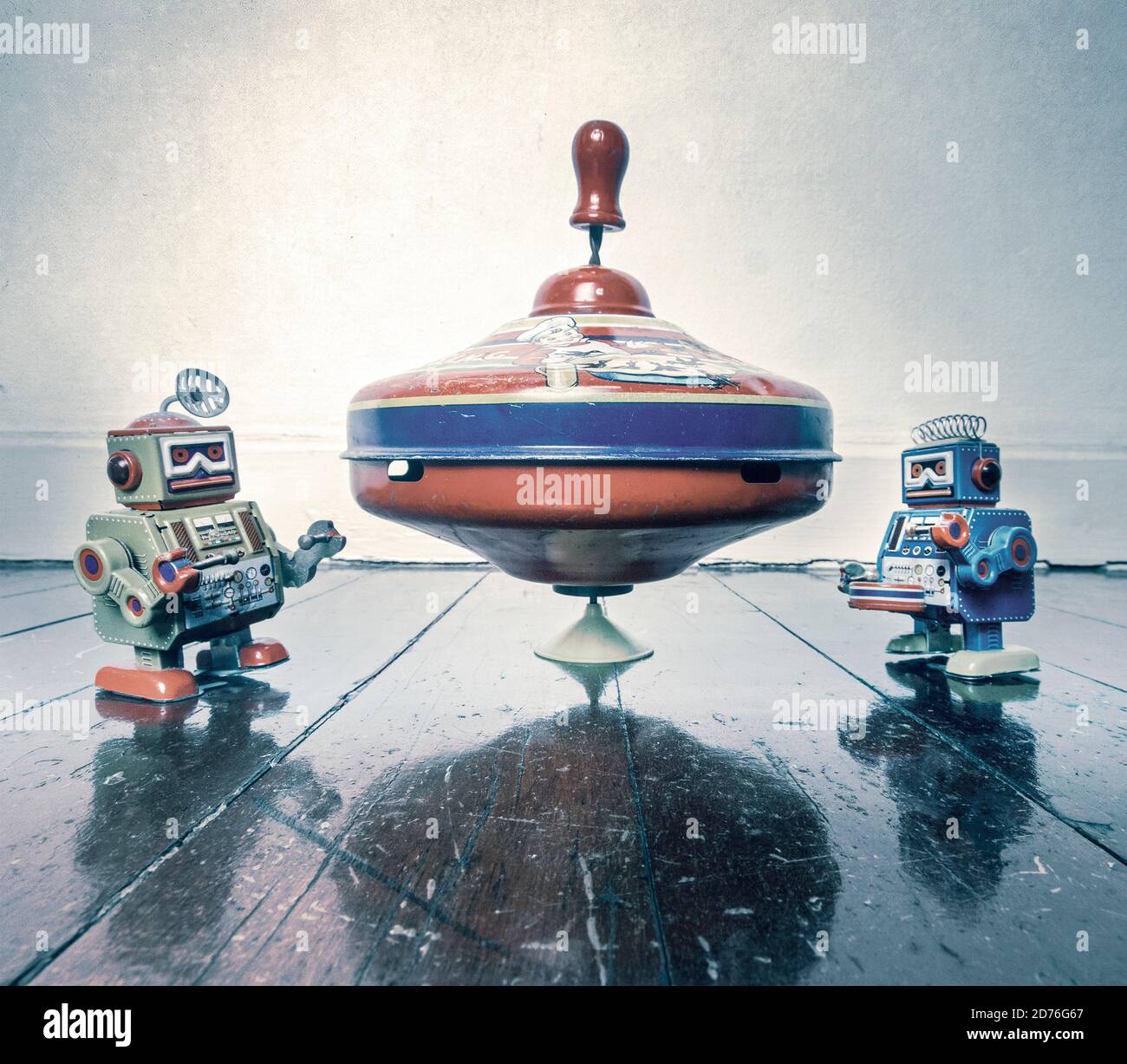 vintage spinning top and two small robot toys Stock Photo - Alamy