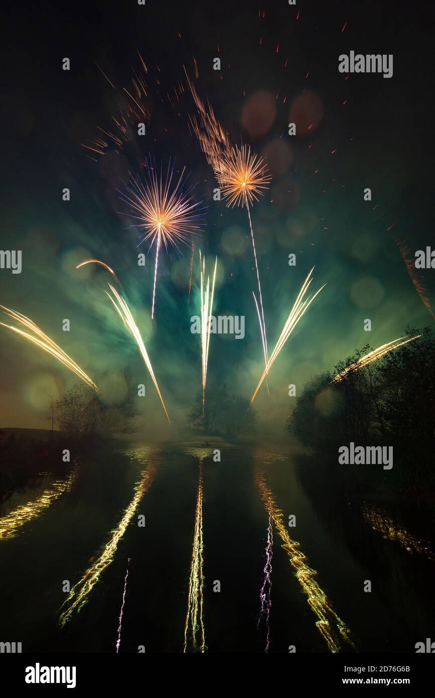 Spectacular and colourful firework display set against a dark Autumn ...