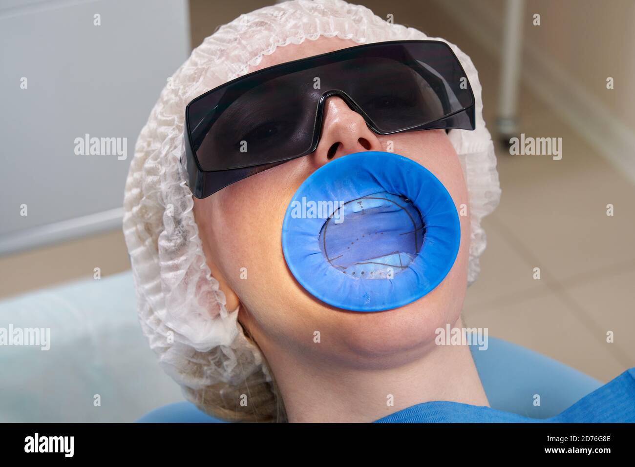 Patient getting dental treatment at dentist office with dental rubber ...