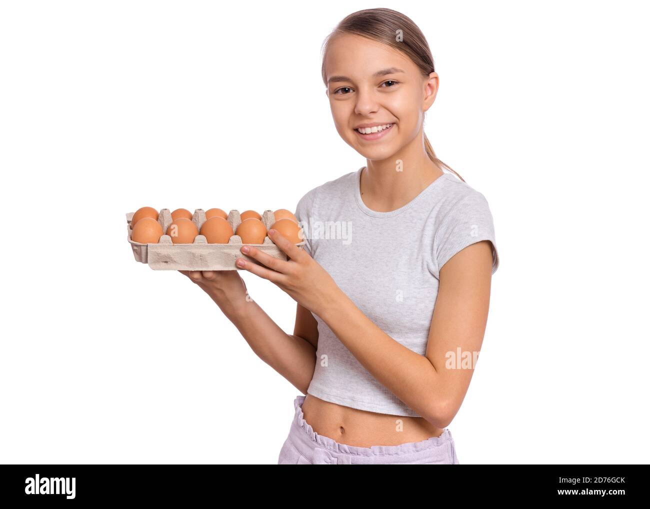 Happy cute teen girl holding brown eggs in box, isolated on white ...