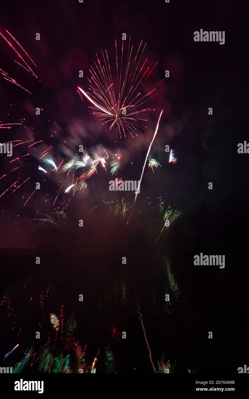Spectacular and colourful firework display set against a dark Autumn ...