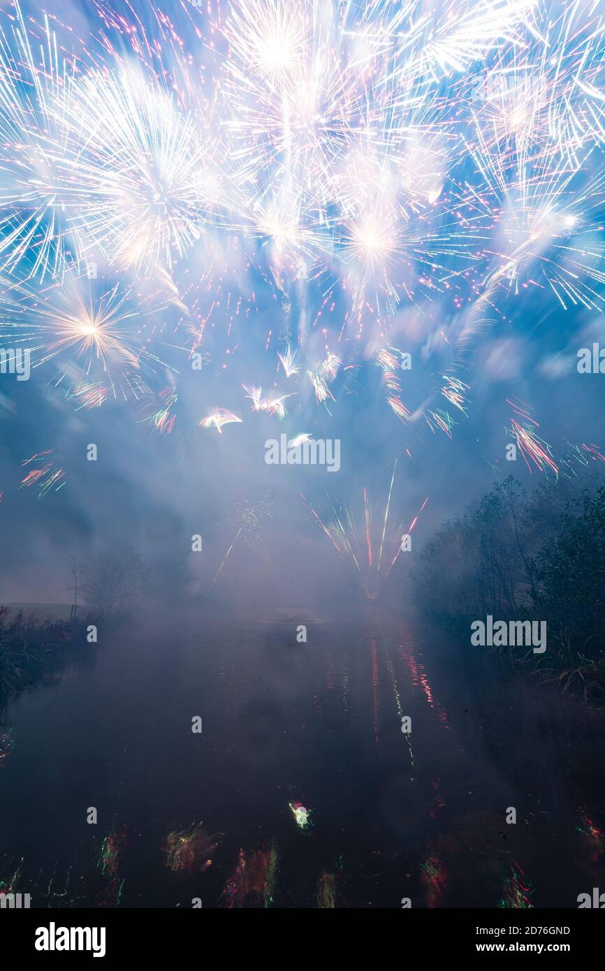 Spectacular and colourful firework display set against a dark Autumn ...