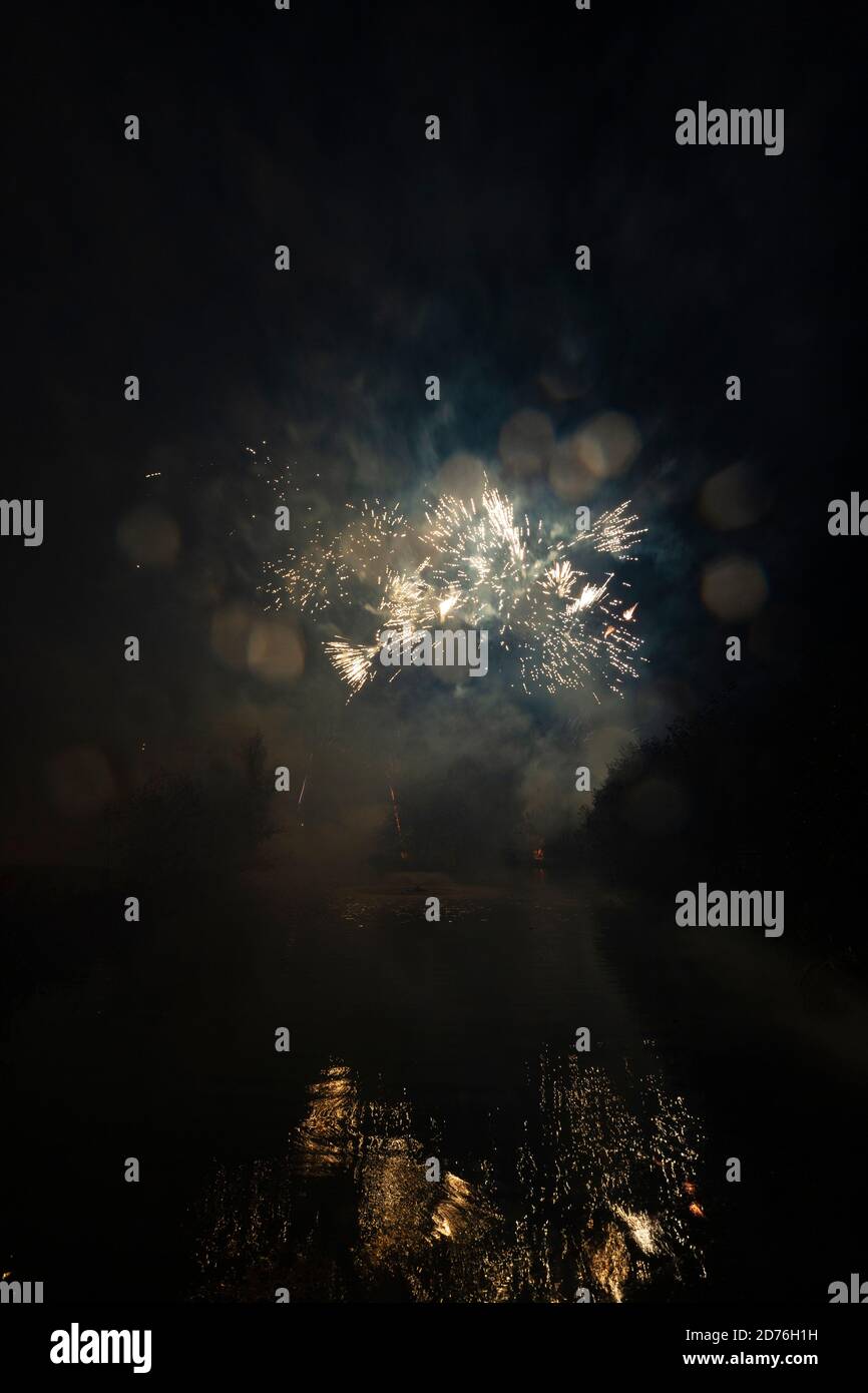 Spectacular and colourful firework display set against a dark Autumn ...