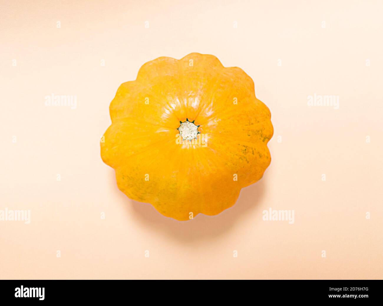Pumpkin in the middle of a beige background. Simple flat lay Stock ...