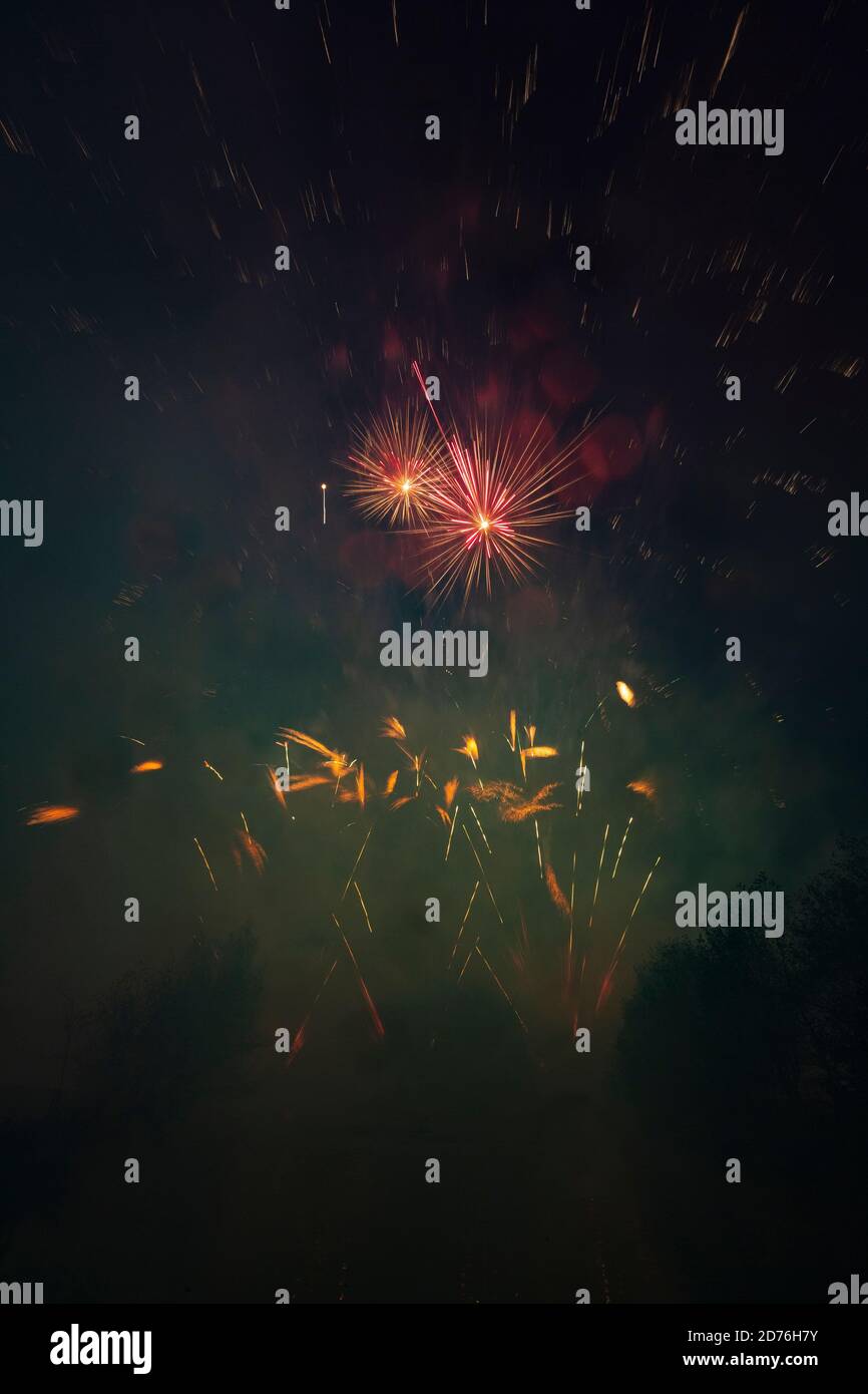 Spectacular and colourful firework display set against a dark Autumn ...