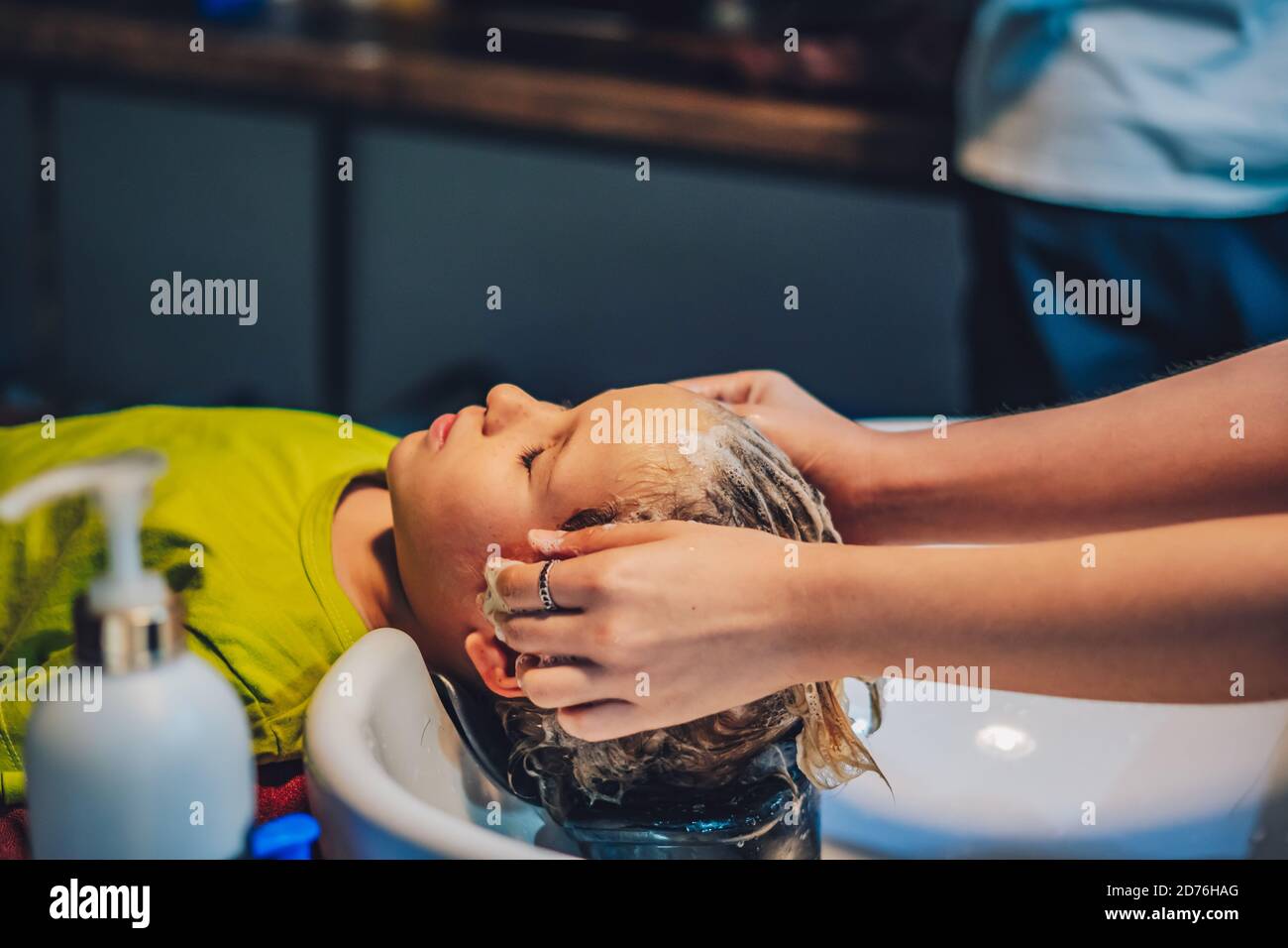 Wet Head White Blond little Boy lie leaning on over sink. Woman female ...