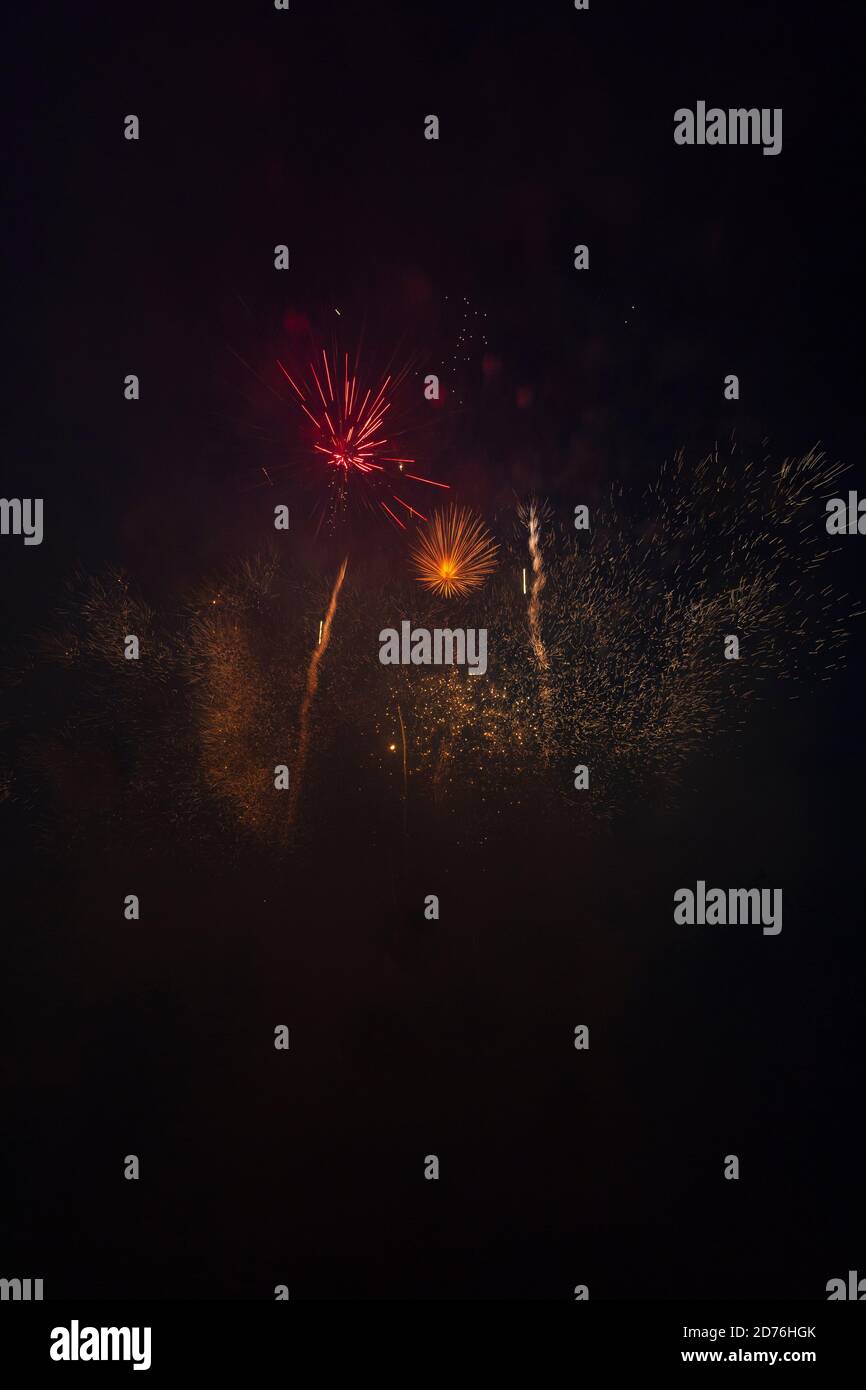 Spectacular and colourful firework display set against a dark Autumn ...