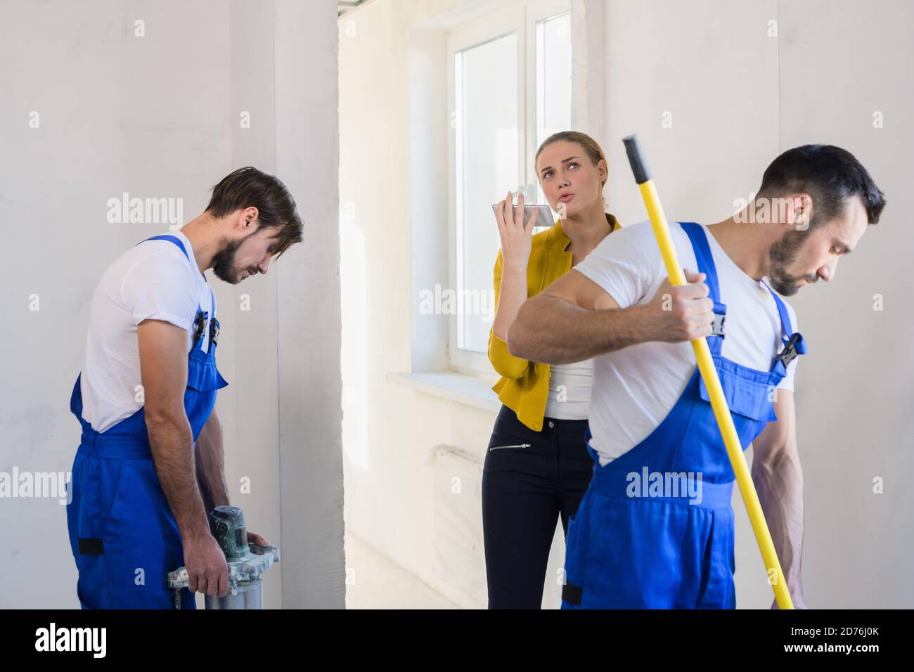 Foremen are doing repairs. They use a roller and mixer Stock Photo - Alamy