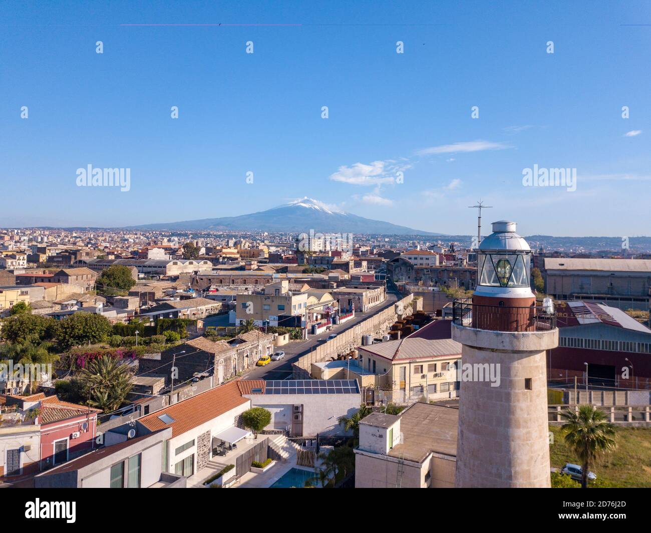 Landscape of buildings in Catania with the view of Etna volcano, Sicily ...