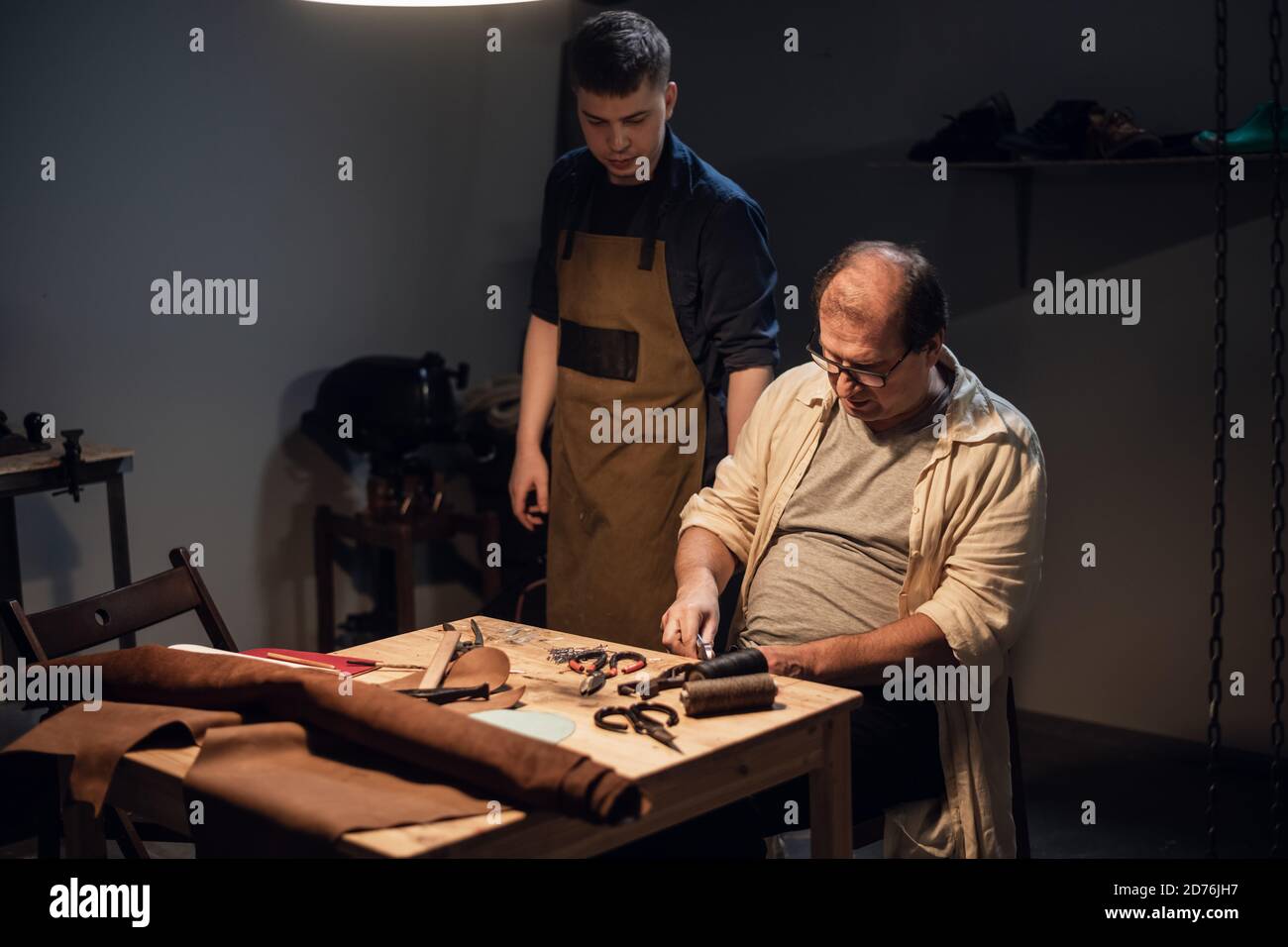 father-shoemaker prepares a successor in the family business of manual ...
