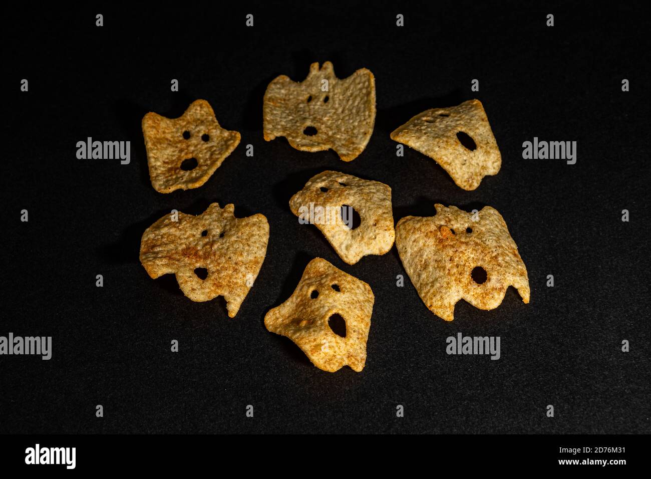 Halloween ghost chips on a black background Stock Photo - Alamy