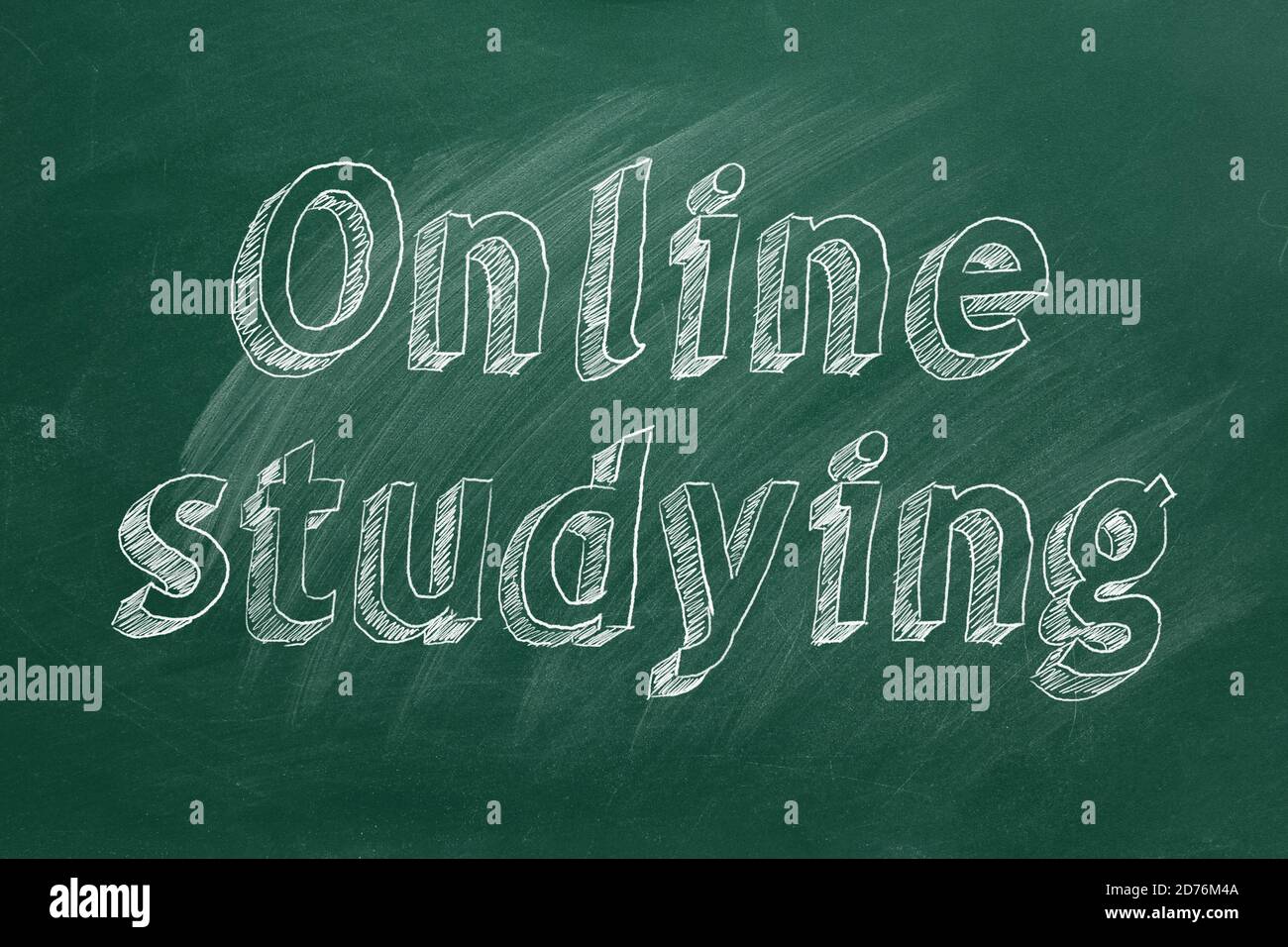 Lettering ONLINE STUDYING are drawn with chalk on a green blackboard. Homeschooling distance learning concept. E learning online education and inter Stock Photo Alamy