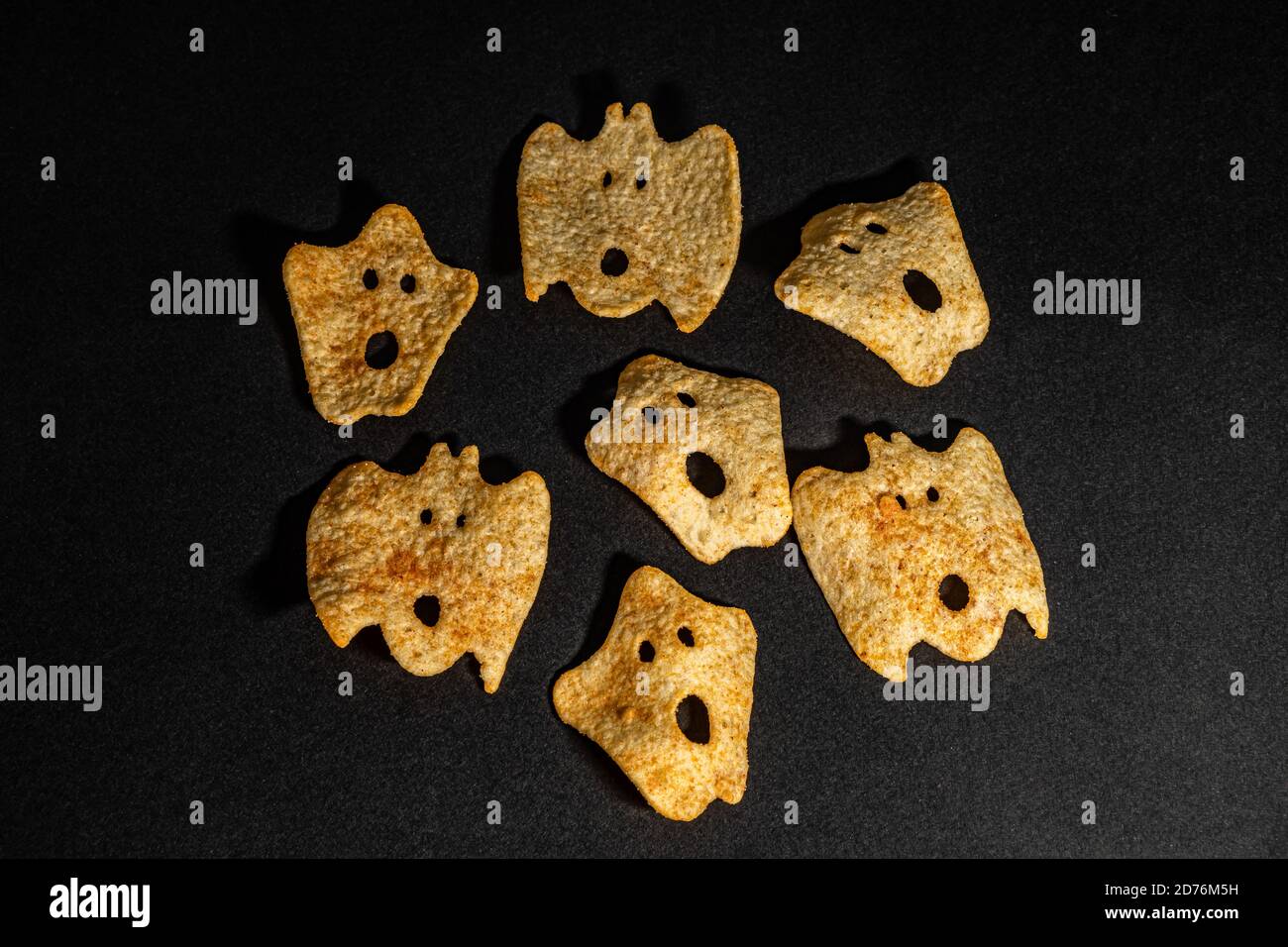 Halloween ghost chips on a black background Stock Photo - Alamy