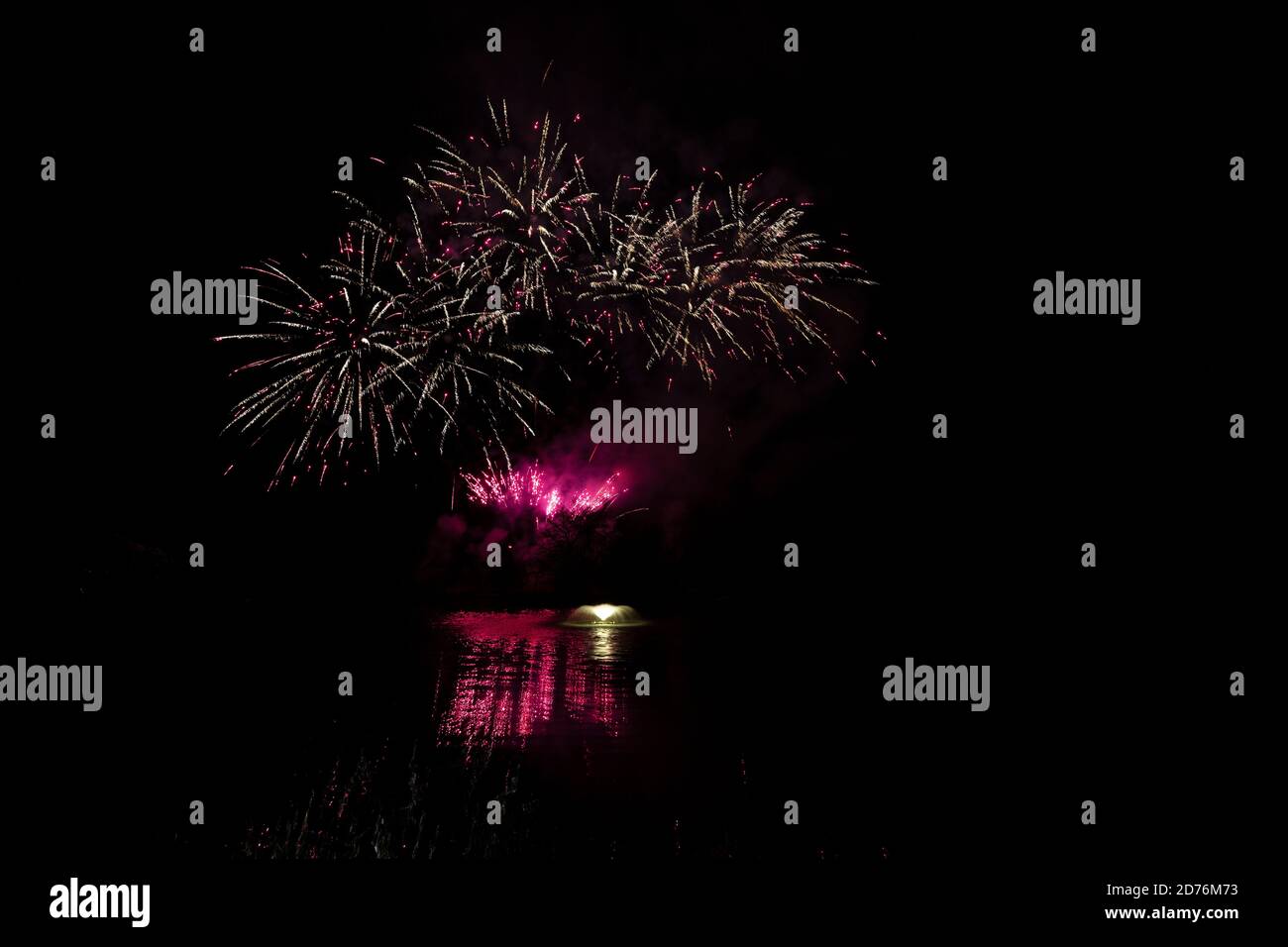 Spectacular and colourful firework display set against a dark Autumn ...