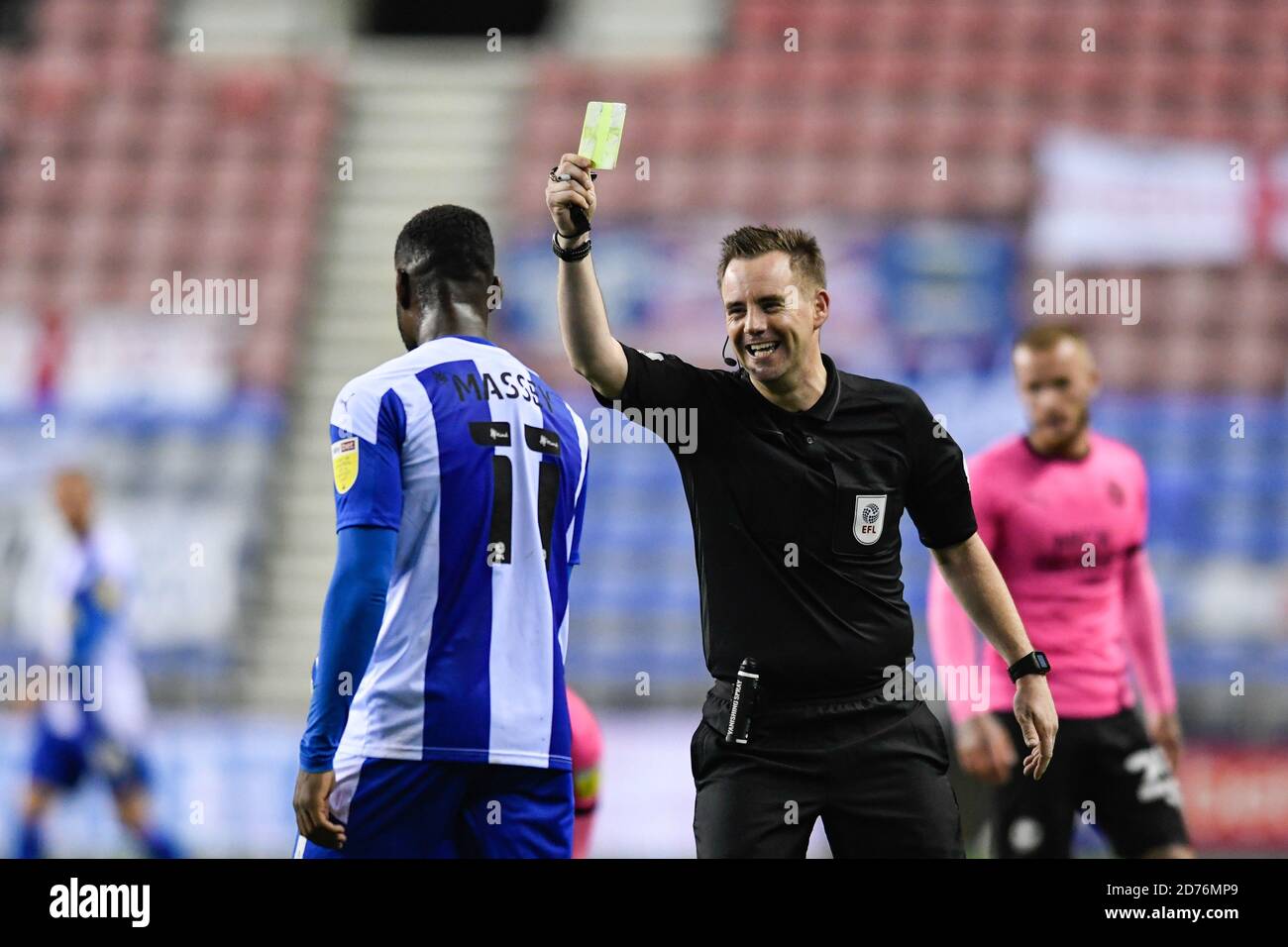 Referee, Ross Joyce smiles as he shows Gavin Massey (11) of Wigan ...