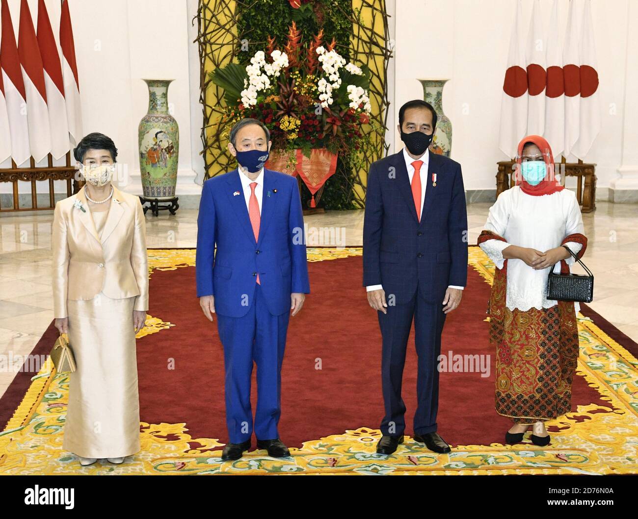 Japanese Prime Minister Yoshihide Suga (2nd from L) and his wife Mariko ...