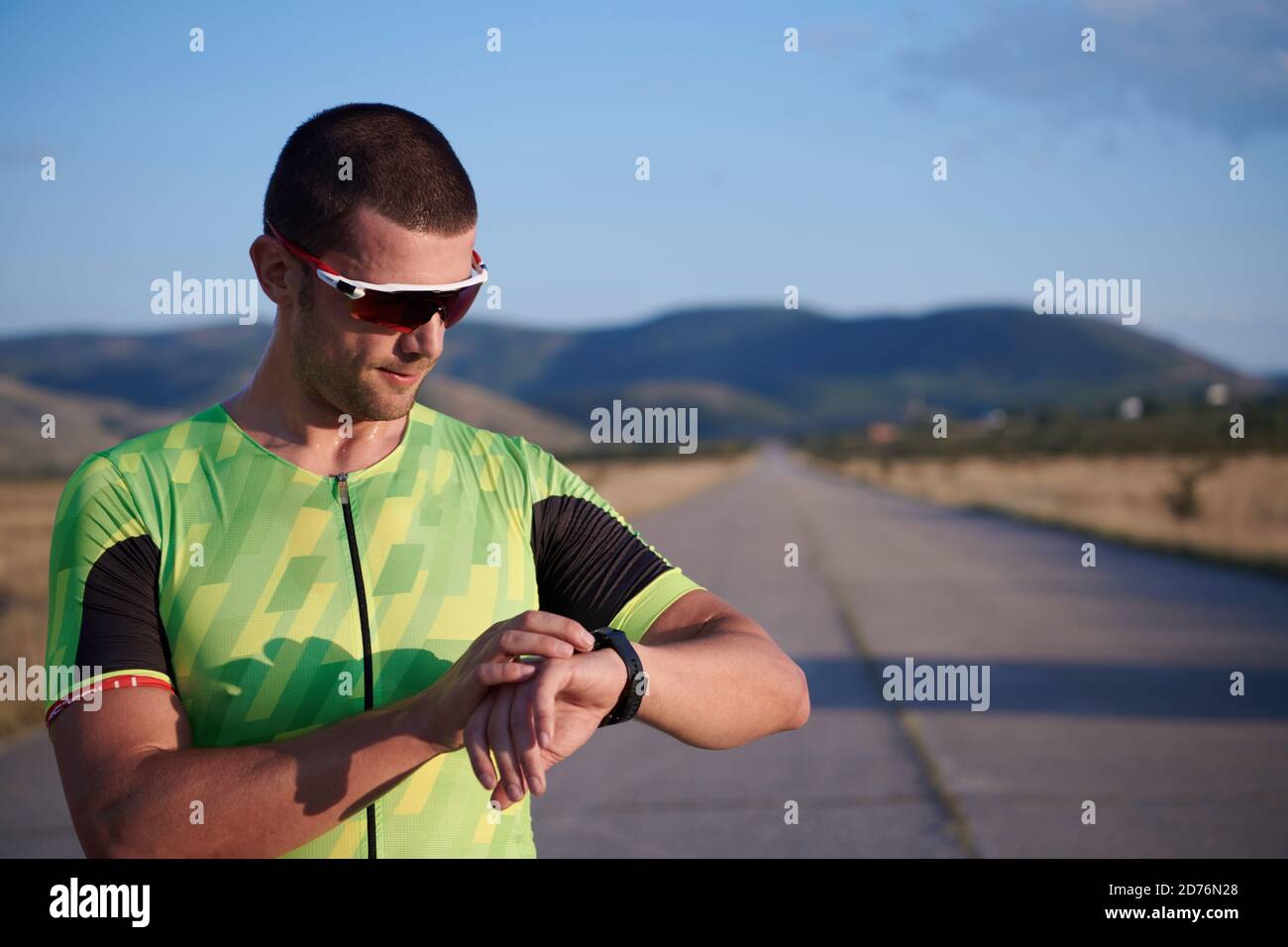 triathlon athlete resting and setting smartwatch Stock Photo - Alamy