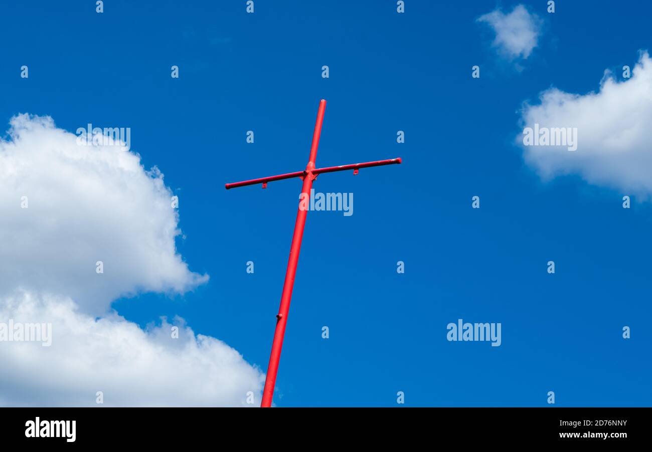 Red boat mast detail against blue sky and white clouds, south bank ...