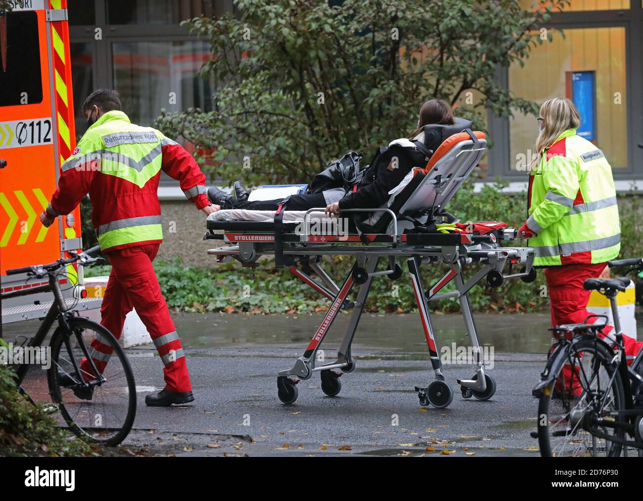 Cologne, Germany. 21st Oct, 2020. Paramedics are driving a woman to the ...