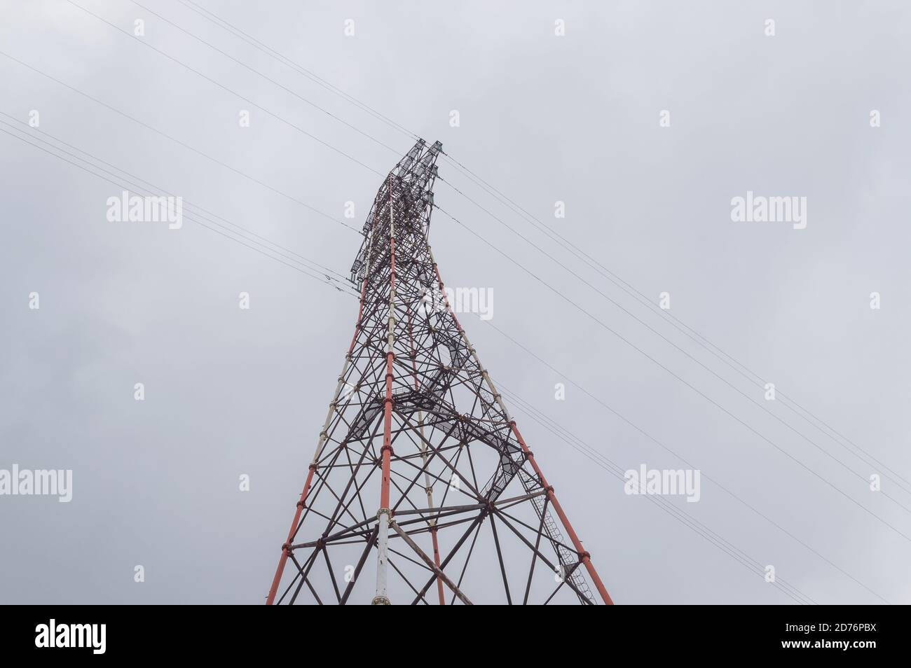 view from below on power line support rising above in skies Stock Photo ...