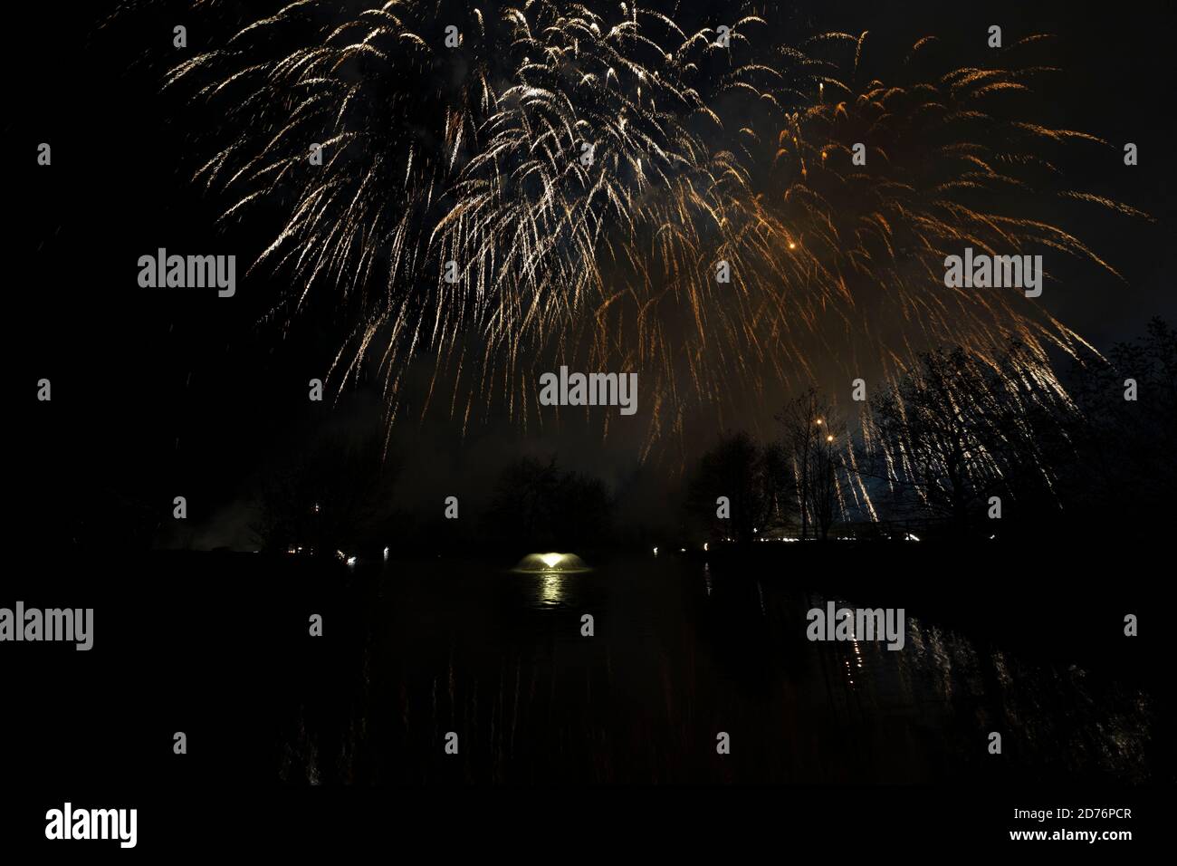 Spectacular and colourful firework display set against a dark Autumn ...